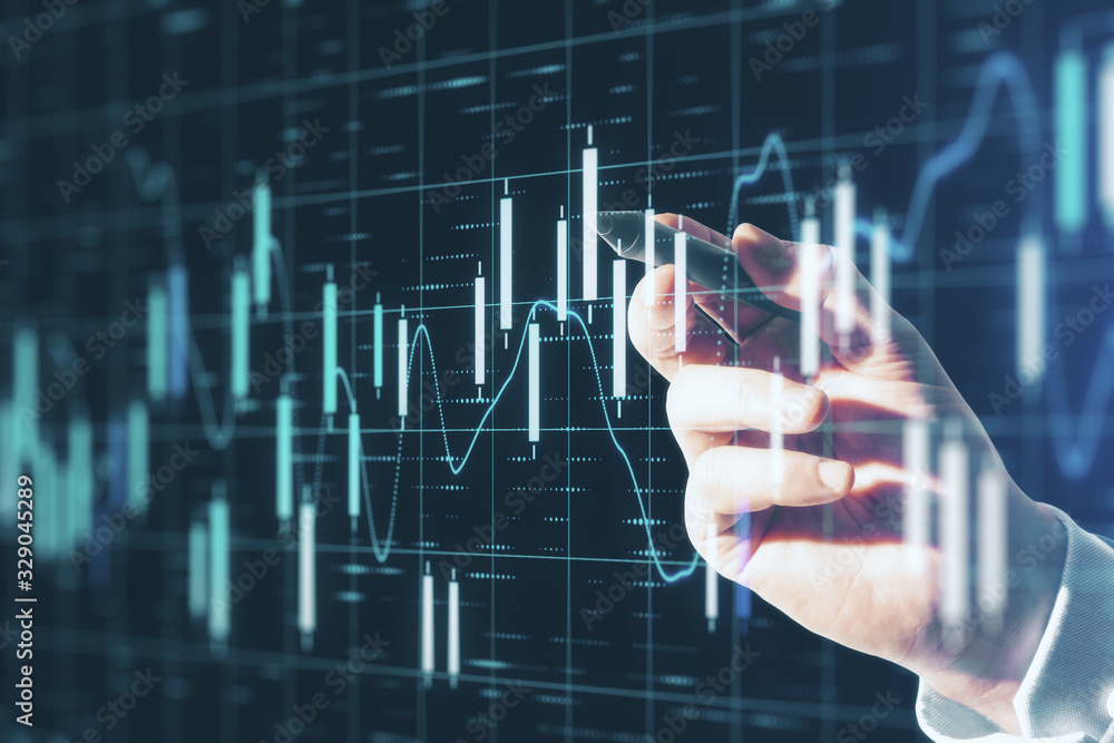 Trading concept with man hand pushing digital screen with going up ...