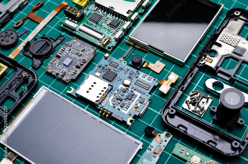 Boards and components of disassembled old mobile phones with ...