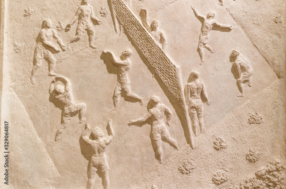 The relief facade of the building. Plaster with a picture of the plot ...