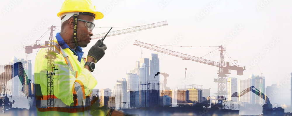The double exposure image of the engineer standing on site, he is ...