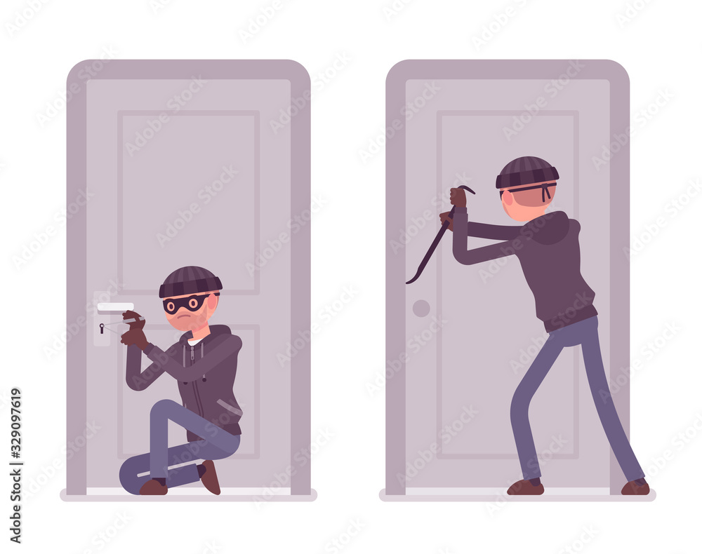 Thief trying to break into the door. Masked housebreaker working with a ...