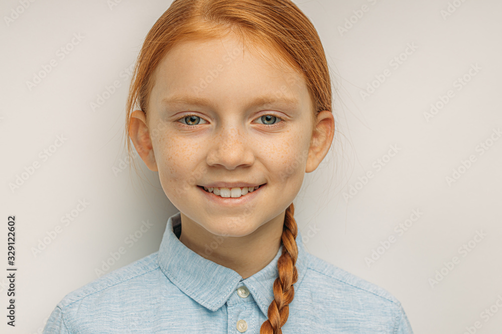 close-up portrait of beautiful positive child girl with red hair ...