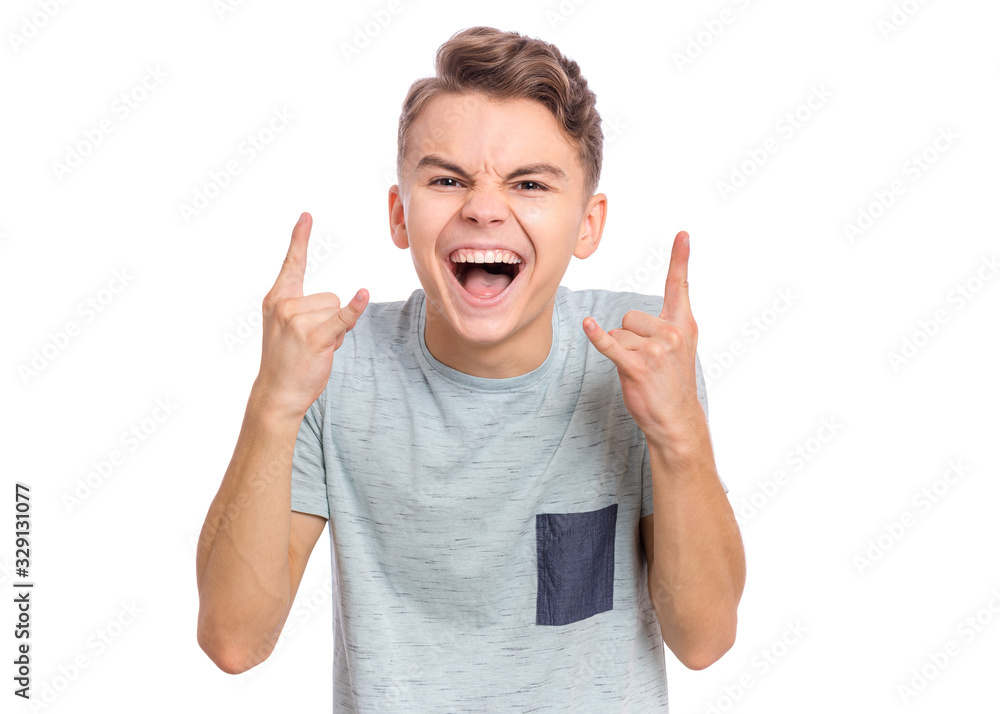 Portrait of teen boy making Rock Gesture, isolated on white background ...