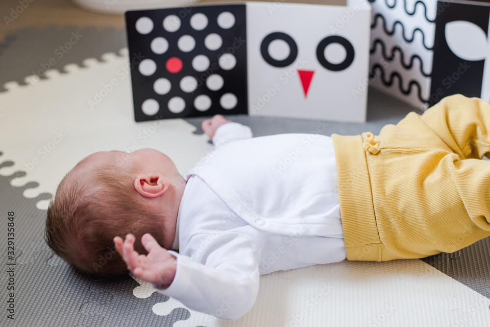 Baby watching Infant Vision Development contrast cards on a playmat, 1 ...