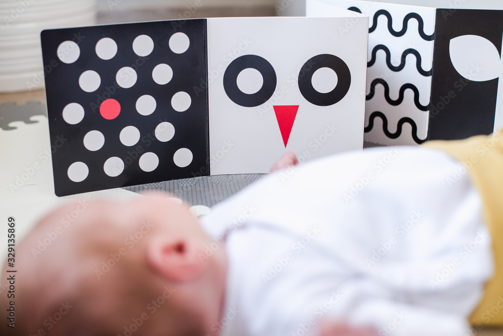 Baby watching Infant Vision Development contrast cards on a playmat, 1 ...