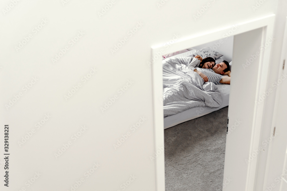 happy young family wakes up early in the morning in bed,top view of a ...