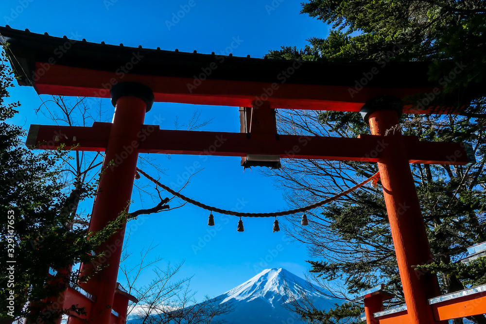 Distant view on Mt Fuji, framed in between orange Torri gate, leading ...