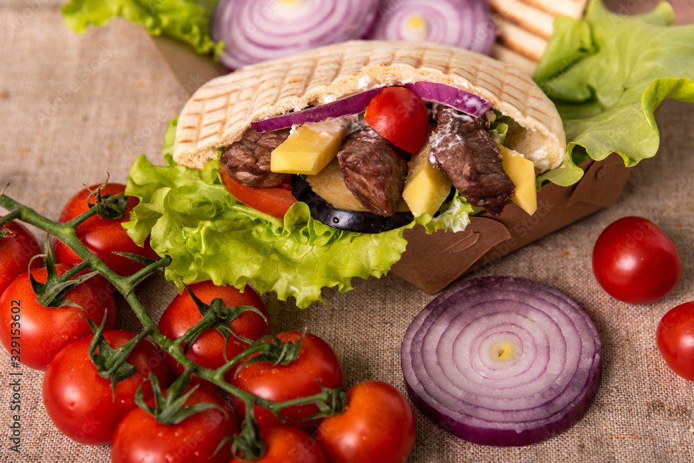 Pita doner kebab with green salad, potato free, tomatoes, cherry ...