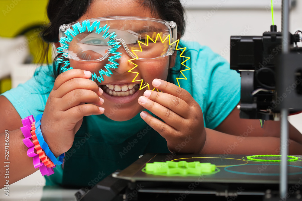 Happy STEM student smiles and shows off the colorful 3d printed shapes ...