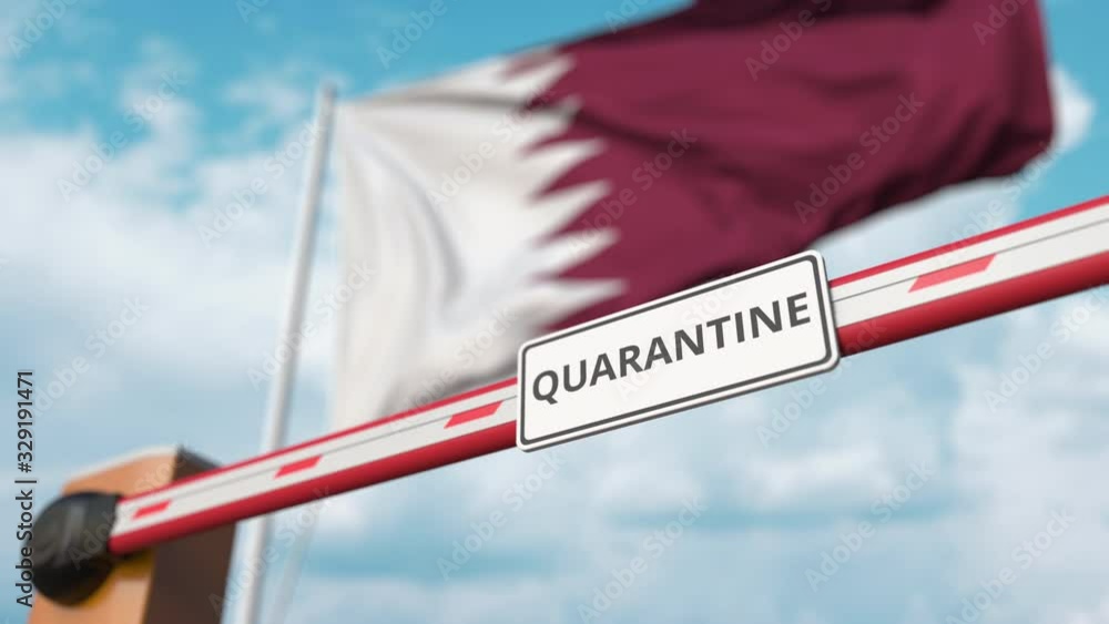 Barrier gate with QUARANTINE sign being closed with flag of Qatar as a ...