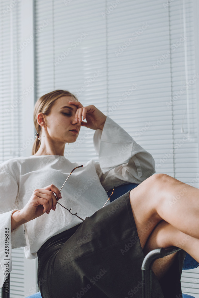 Young business woman take it easy working and resting in office. Niksen ...