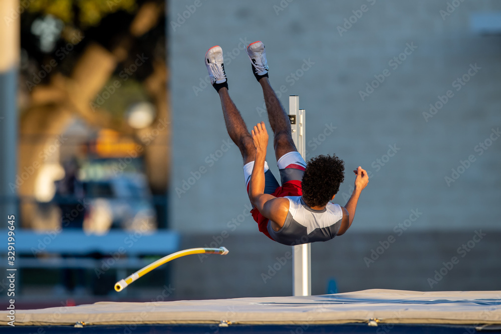 Young boy competing in the high jump at a track meet Stock Photo ...