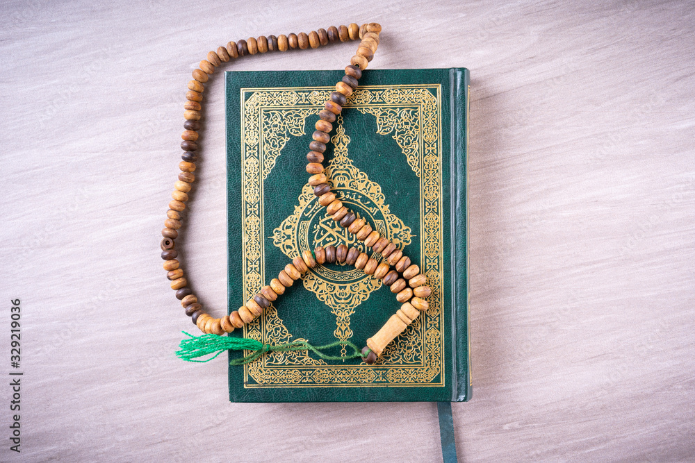 Qoran and Tasbih (rosary beads). Islamic Concept. The words on the ...