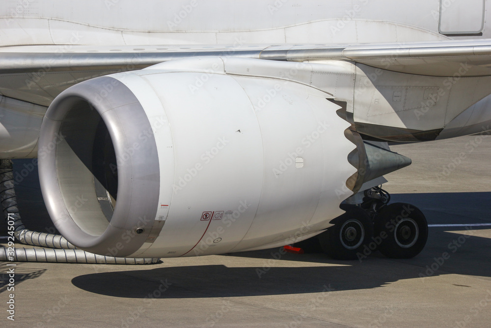 Turbine engine part of airplane with airport runway as background ...