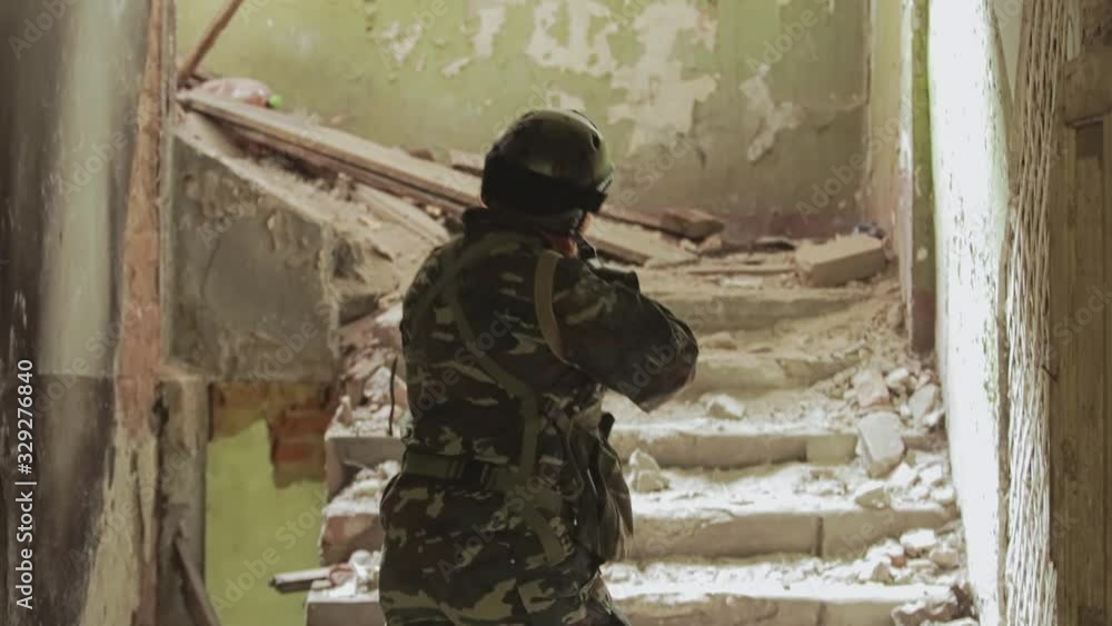 Soldier girl goes to the stairs to the second floor. The assault of the ...