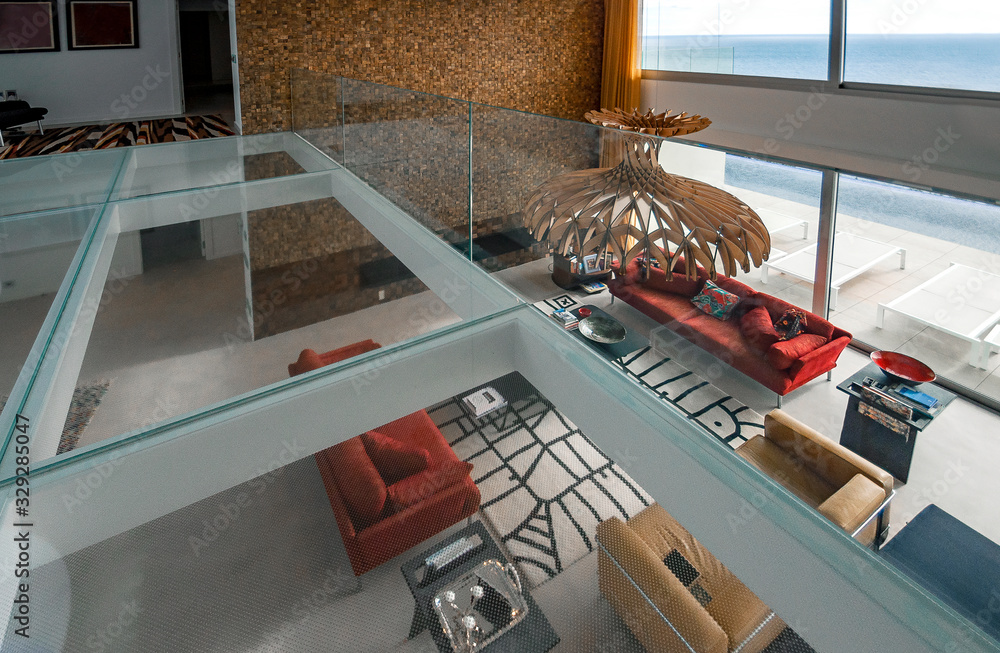 The glass transparent floors in the luxury villa overlook the living ...
