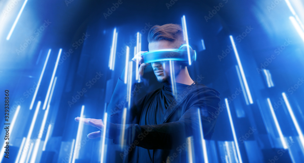 Guy using VR helmet scrolling invisible screen while interacting with ...