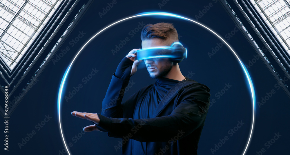 Guy using VR helmet scrolling invisible screen while interacting with ...