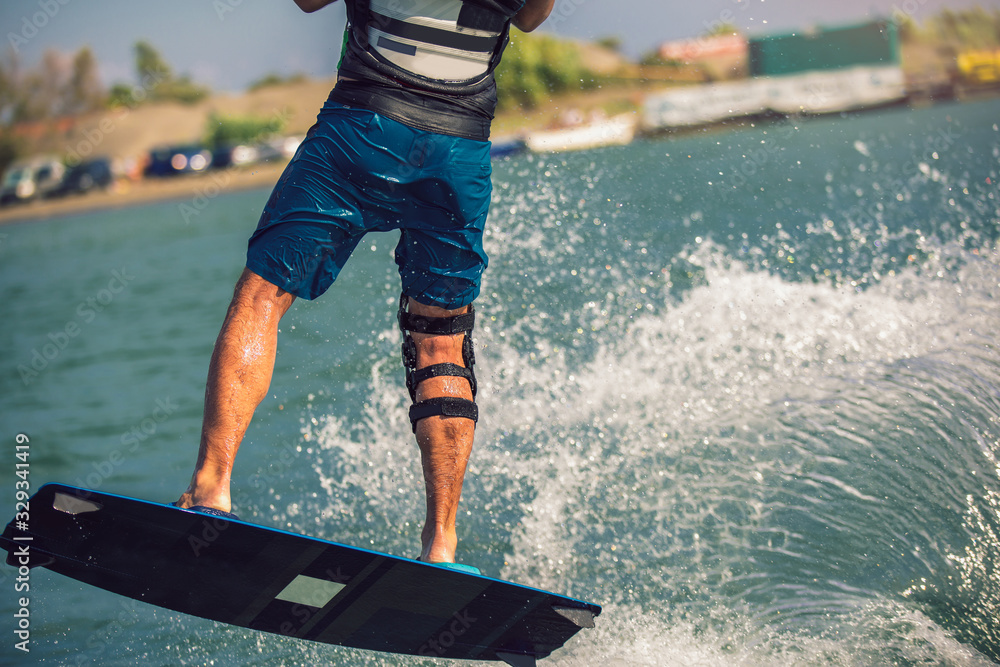 Professional kiter makes the difficult trick on a river. Kitesurfing ...