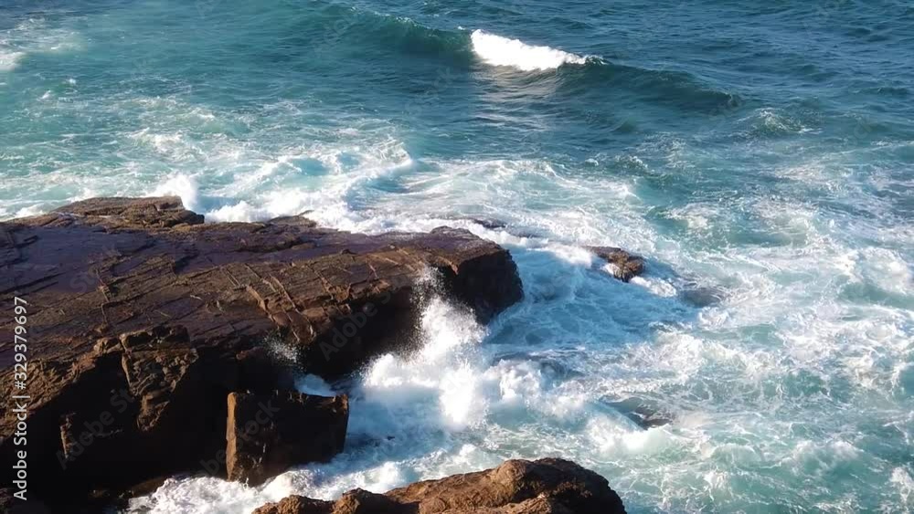 Ocean waves flooding on rocky shore, showing extreme force of ocean ...