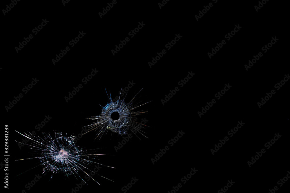 cracks on a black background on broken glass from bullet shots Stock ...