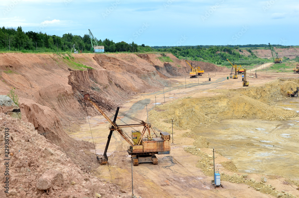 Huge mining excavators in the limestone open-pit. Biggest digger ...
