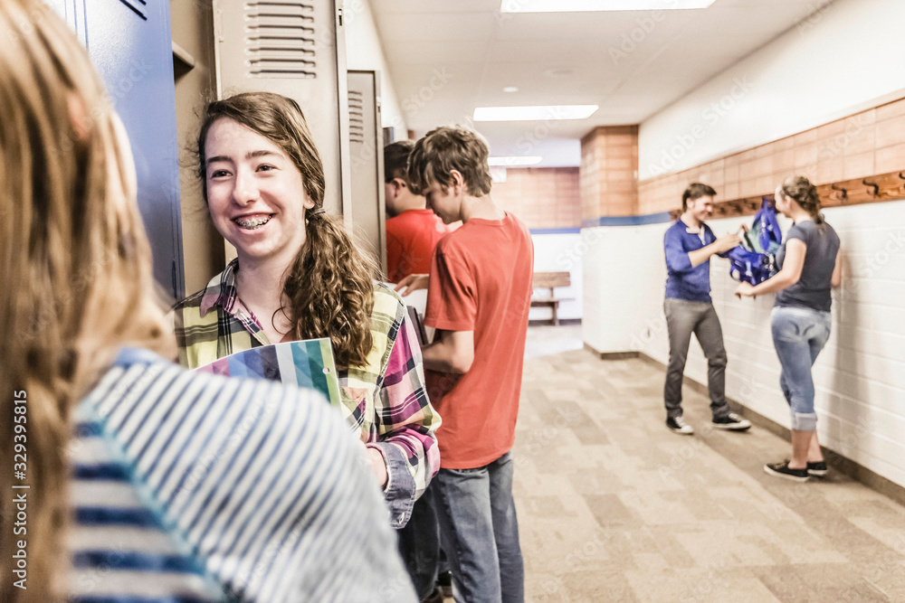 School kids hanging out in the hallway and at the lockers of their ...