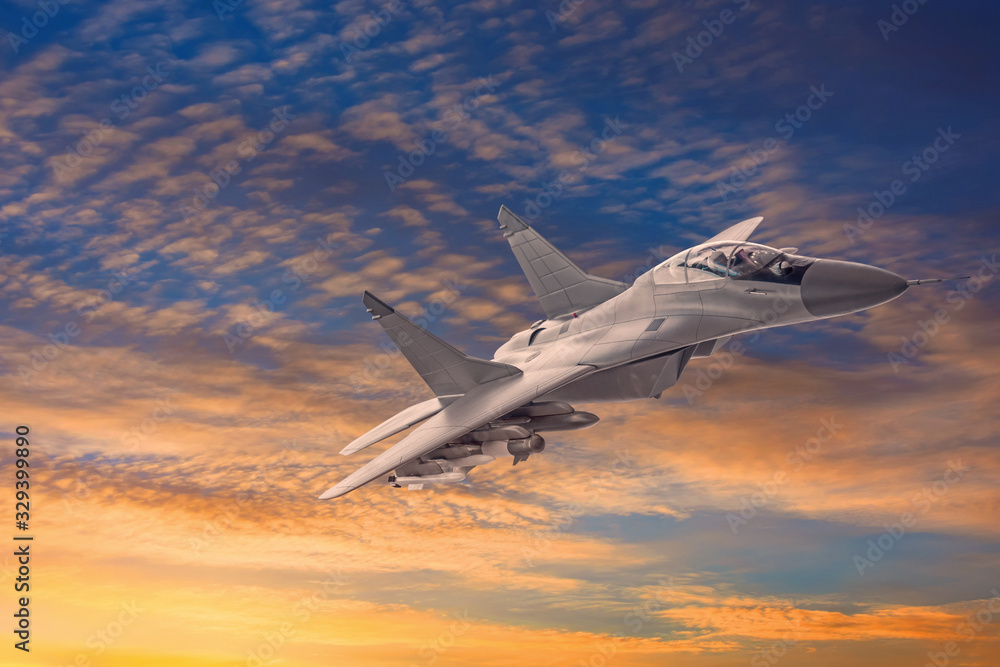 Climbing military combat fighter jet against the backdrop of sunset ...