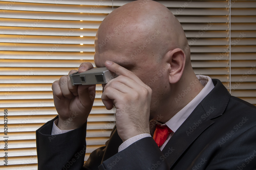 Spy photographs secret materials on a mini camera, collecting ...