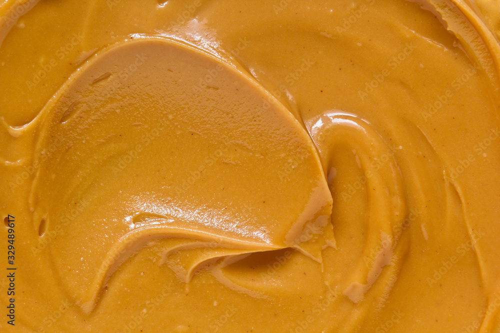 Peanut butter texture background. Brown nut paste smear closeup ...
