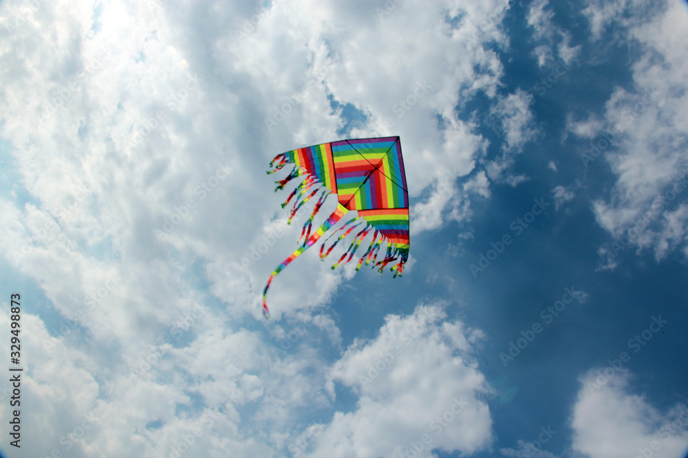 Papalote de colores volando en el cielo Stock Photo | Adobe Stock