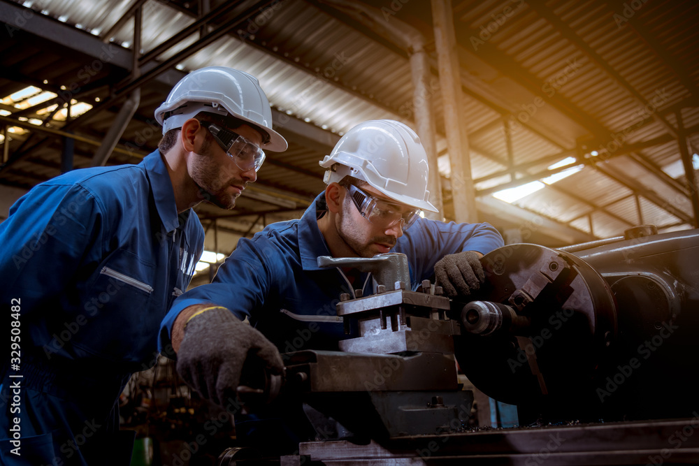 The Industry engineering wearing safety uniform used Vernier caliper to ...