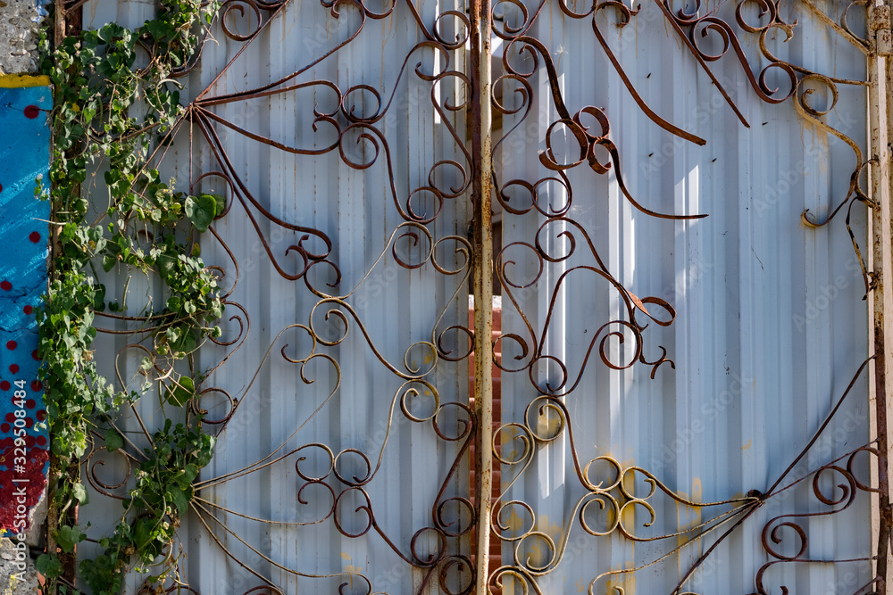 Old wrought-iron gates with openwork wrought-iron texture, rusty metal ...