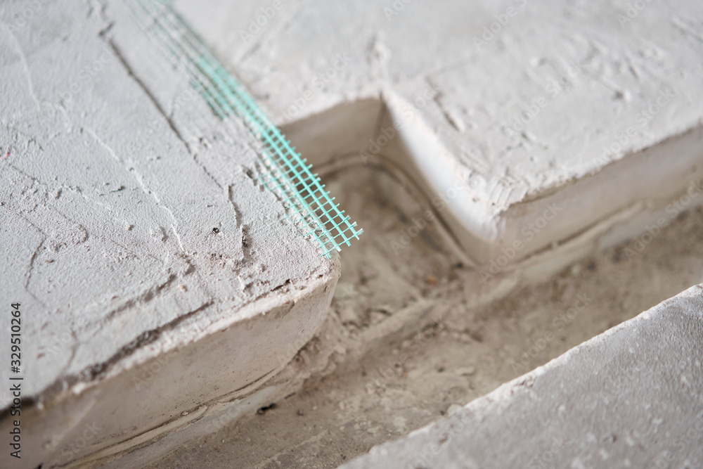 The finished floor screed is reinforced with green mesh. Repair of ...