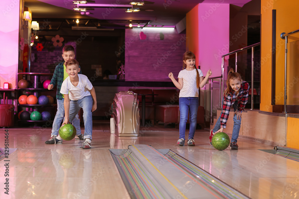 Little children playing bowling in club Stock Photo | Adobe Stock