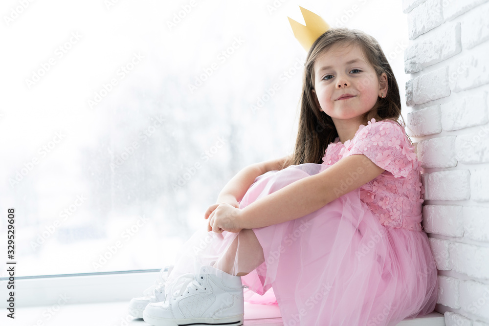 Cute little girl in a princess costume. Pretty child preparing for a ...