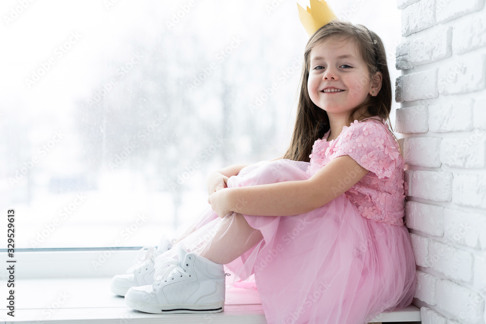 Cute little girl in a princess costume. Pretty child preparing for a ...