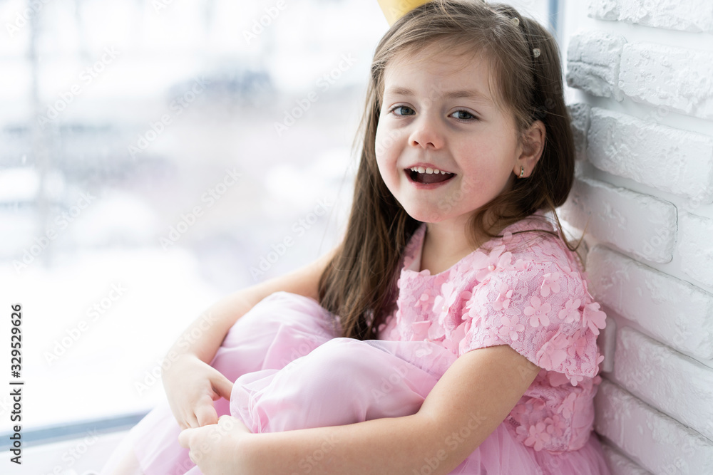 Cute little girl in a princess costume. Pretty child preparing for a ...