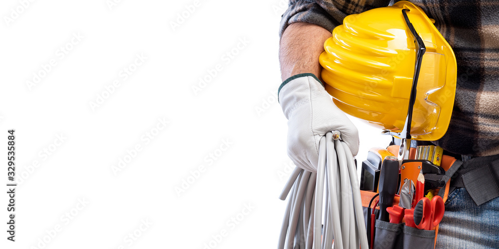 Electrician holds the roll of electric cable in his hand, helmet with ...