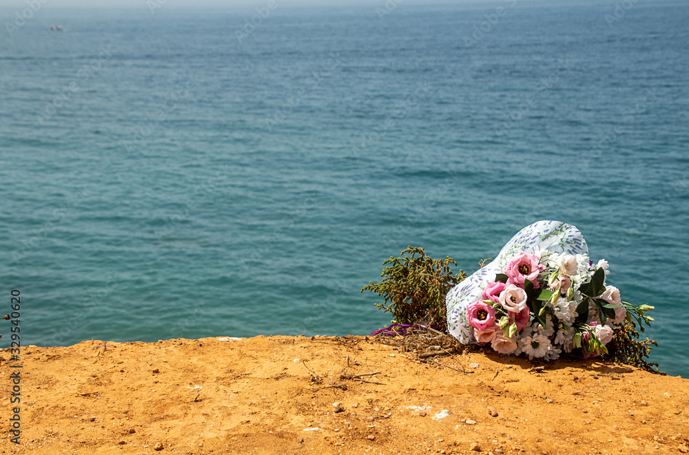 Funeral flowers at the beach. Flower bouquet on doom place, memory ...