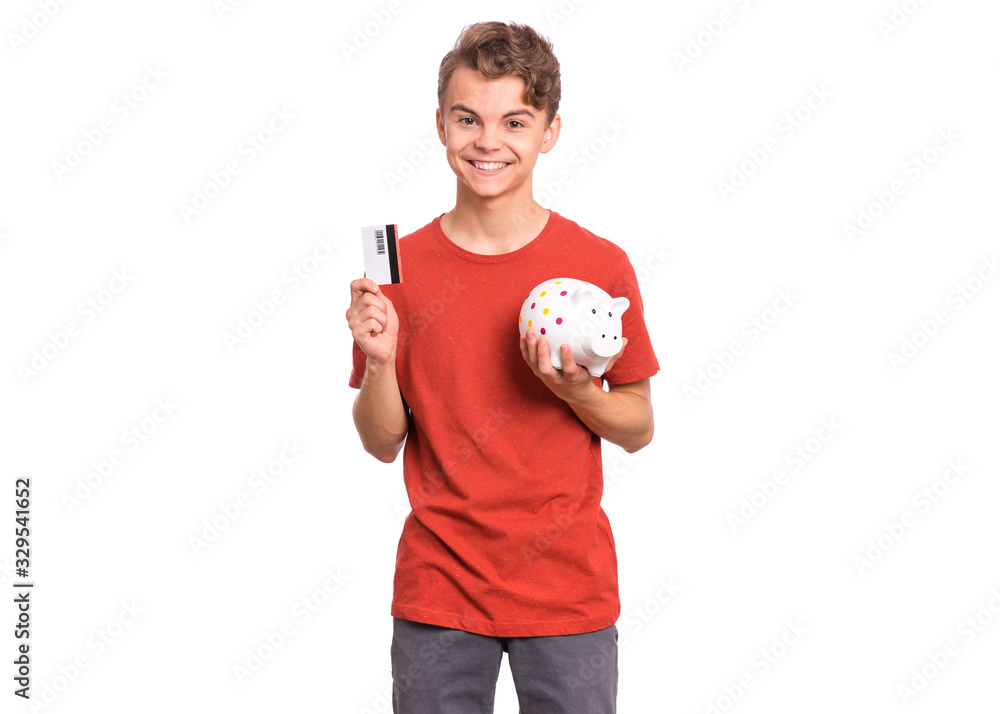 Portrait of happy teen boy holding credit card and Piggy Bank, isolated ...