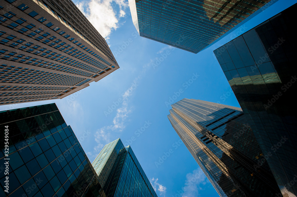 Abstract blue sky view of modern glass and steel skyscrapers from below ...