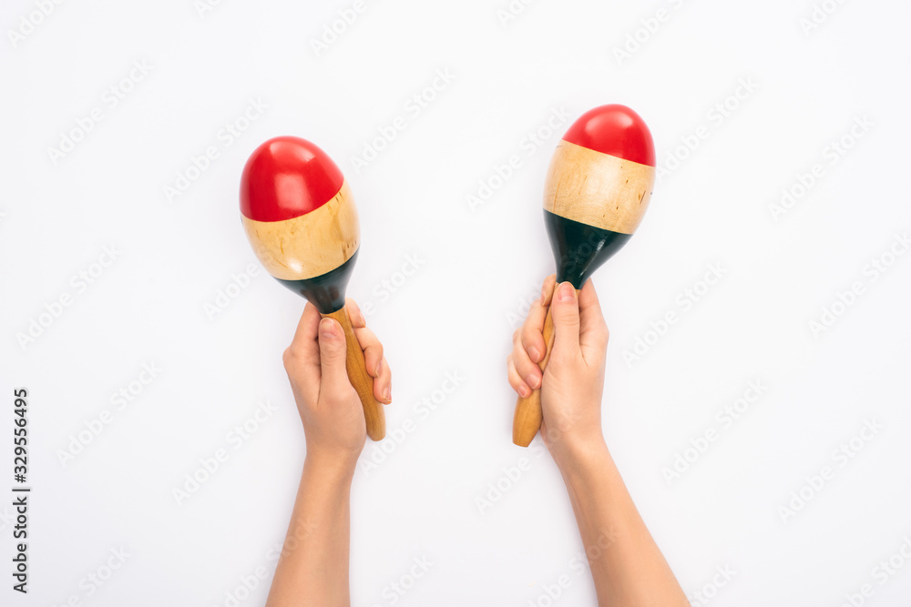 Cropped view of woman holding maracas on white background Stock Photo ...