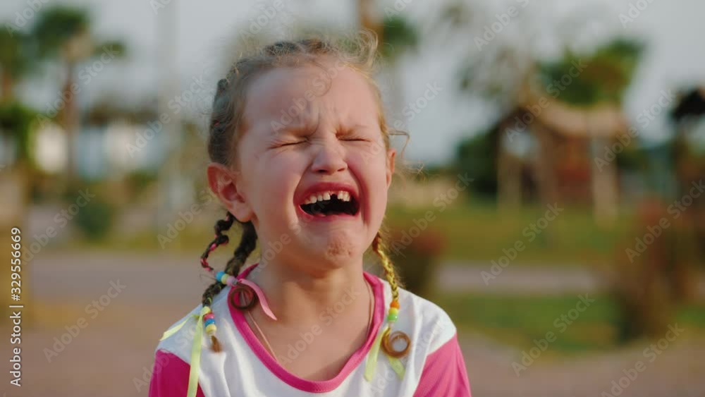 Hardly crying little girl, tears streaming down her face, real emotions ...