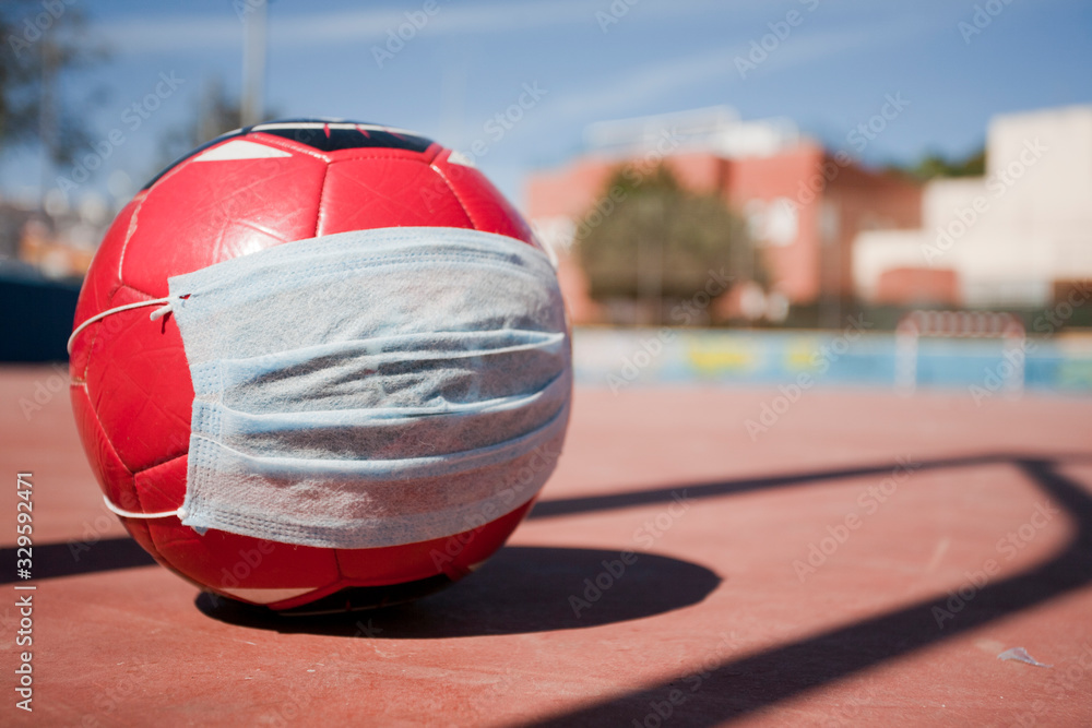 Soccer and coronavirus concept, soccer ball with respiratory mask on ...
