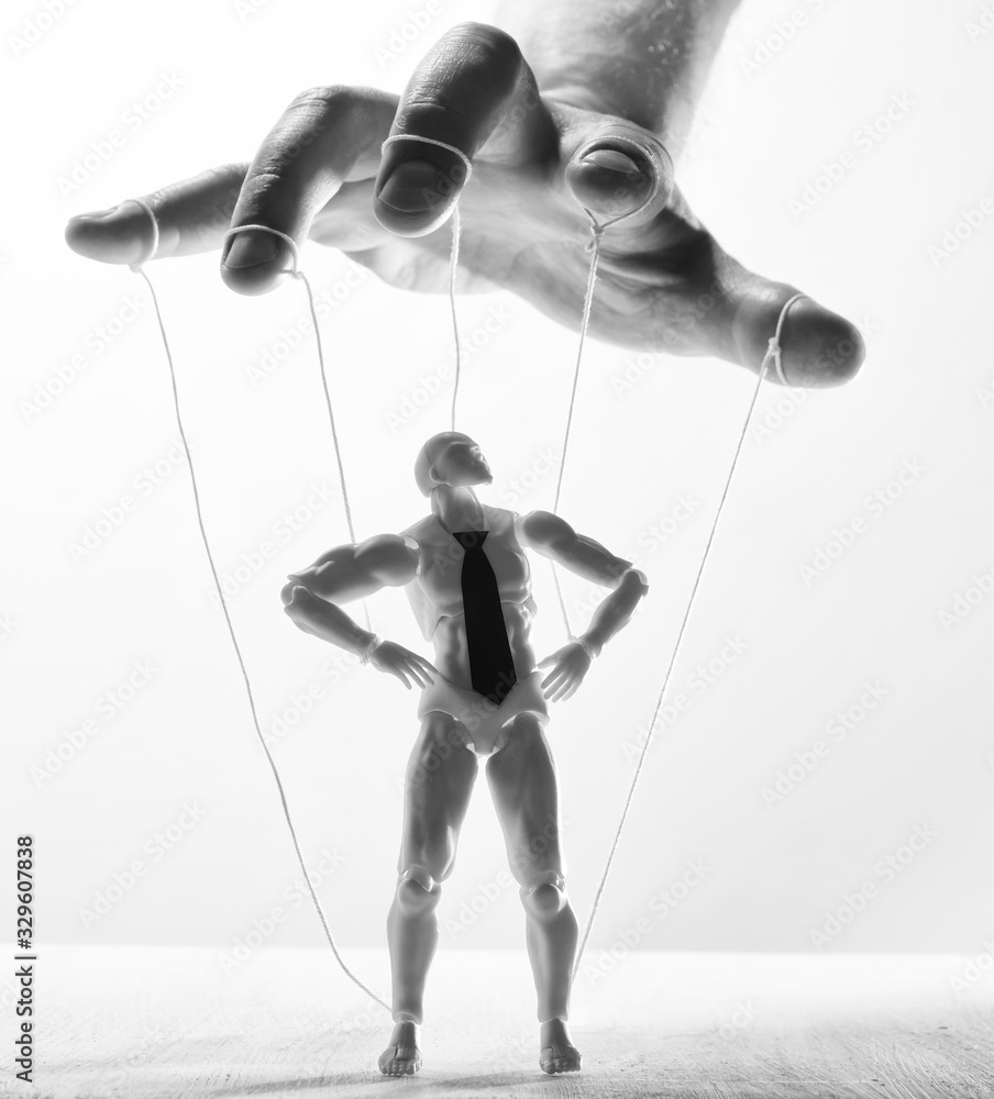 Concept of control. Marionette in human hand. Black and white image ...