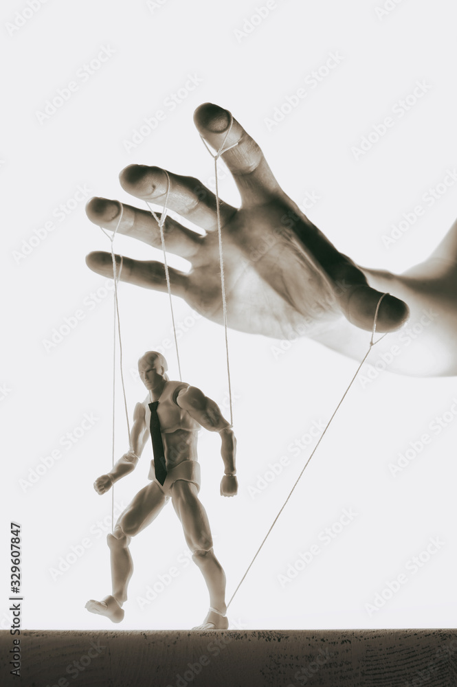 Concept of control. Marionette in human hand. Black and white image ...