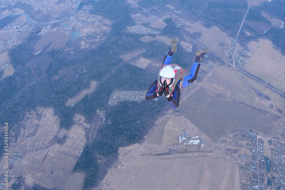 Skydiving. A girl is flying in the sky. Stock Photo | Adobe Stock
