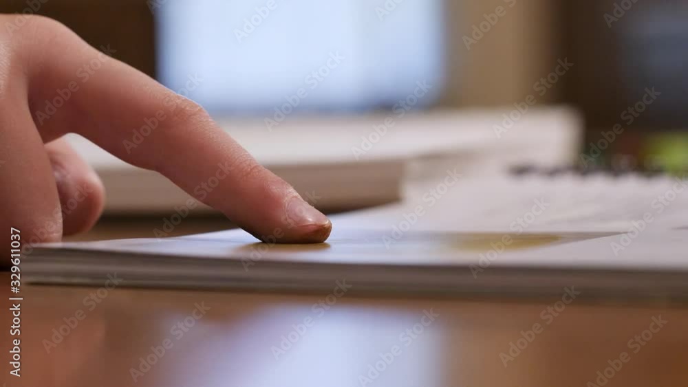 Finger is touching illustration from the book and then draws. Girl is ...