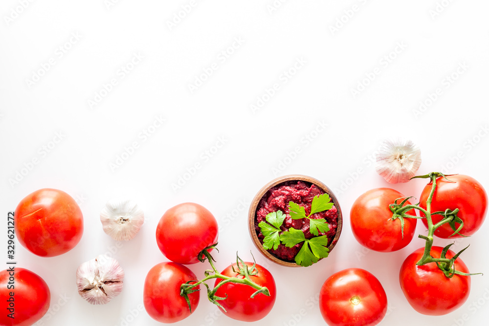 Tomato frame with suase and garlic on white background top-down copy ...